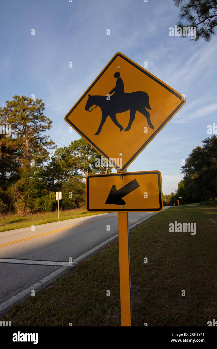 Horse crossing warning sign at the side of a road Stock Photo - Alamy
