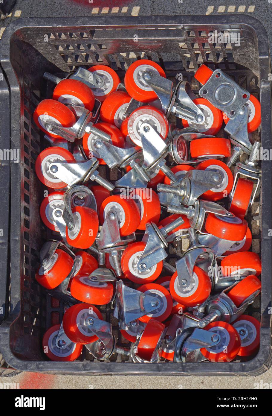 Red caster wheels parts for carts transport in crate Stock Photo - Alamy