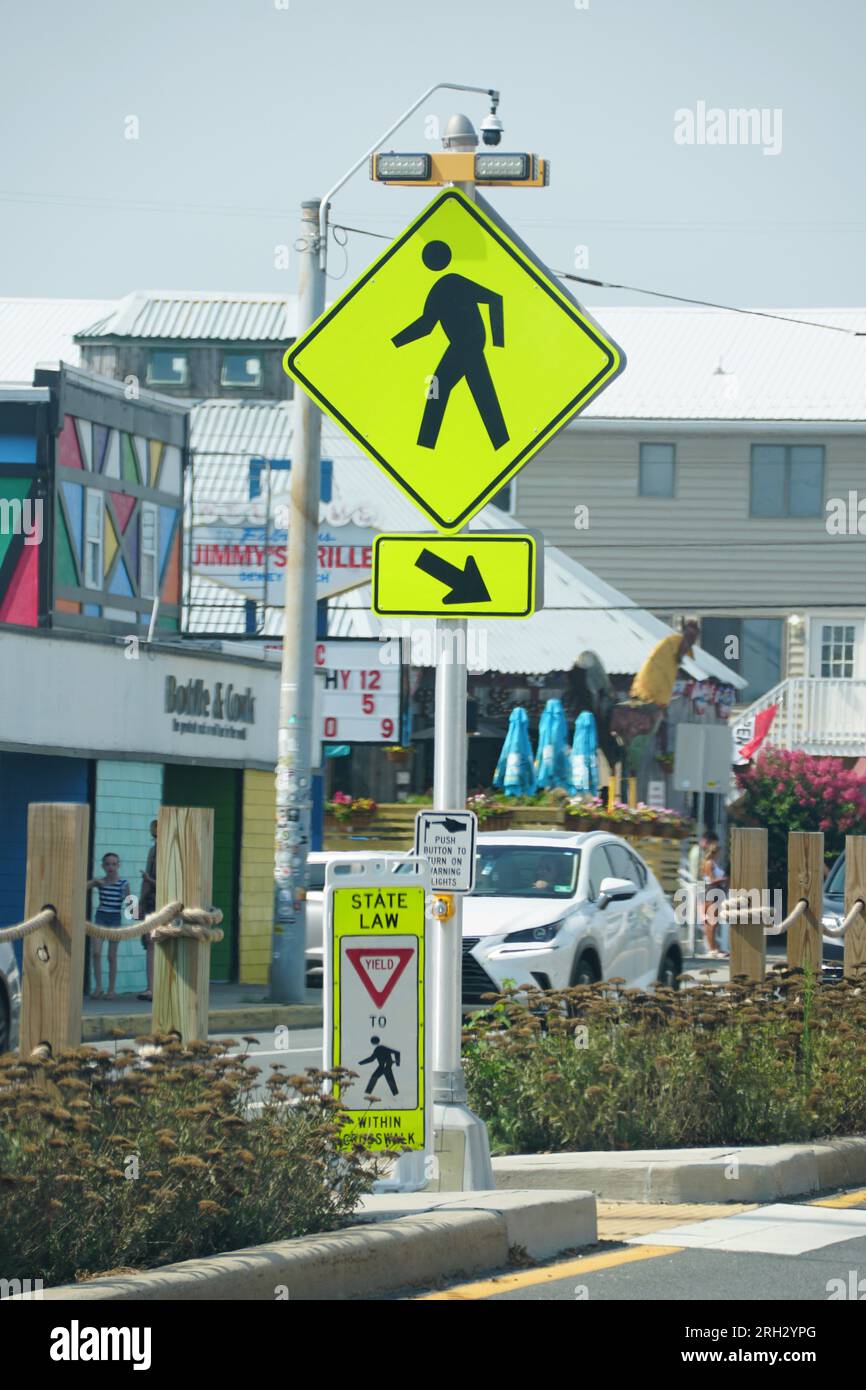 Dewey Beach, Delaware, U.S - August 5, 2023 - A yellow crossing line with blinking lights on the ...