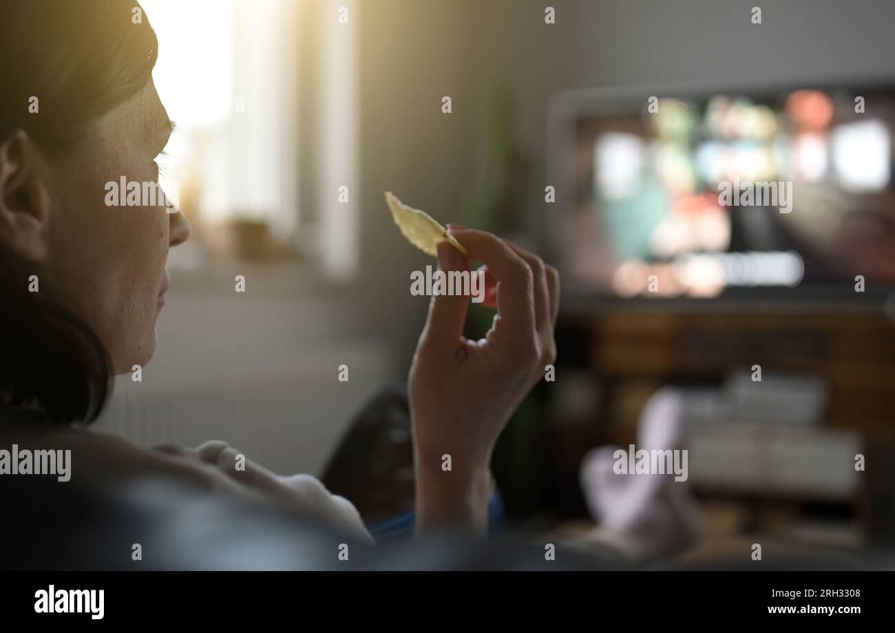 Woman watching smart TV at home. Choosing Internet television program ...