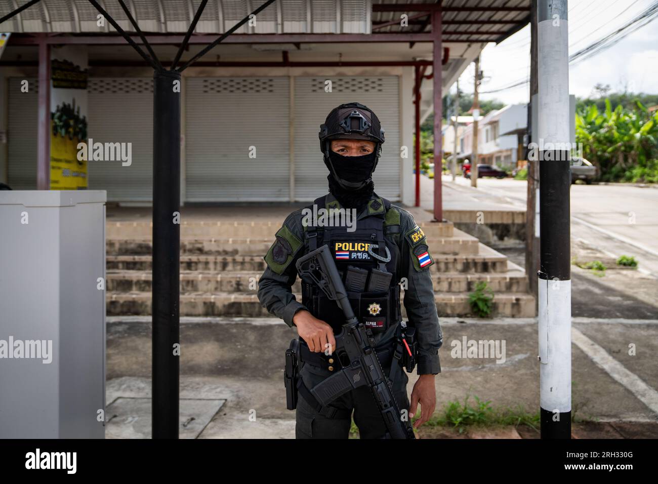 Betong, Thailand. 13th Aug, 2023. An armed border patrol officer stands ...
