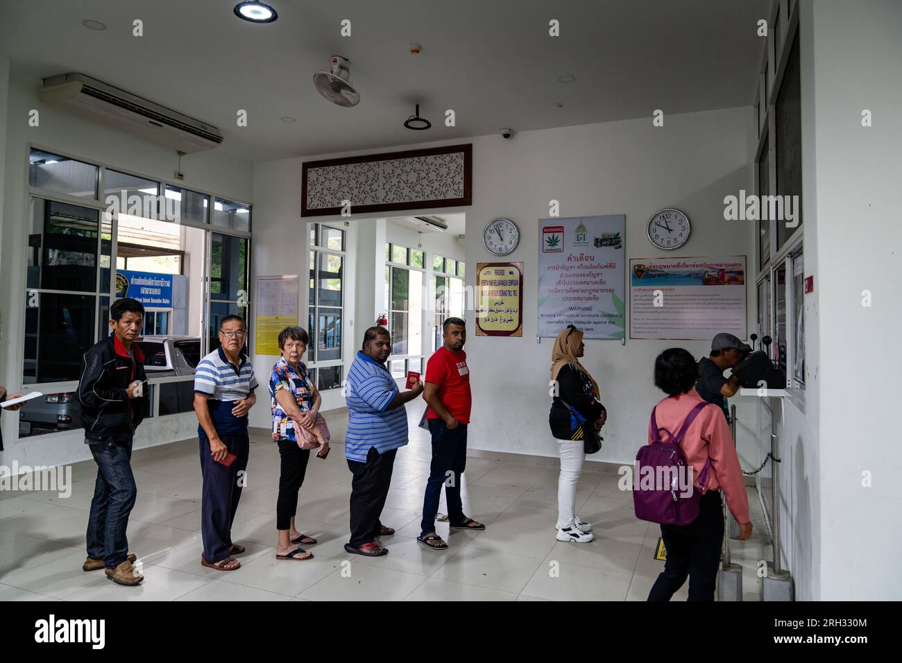 Betong, Thailand. 13th Aug, 2023. People wait in line to have their ...