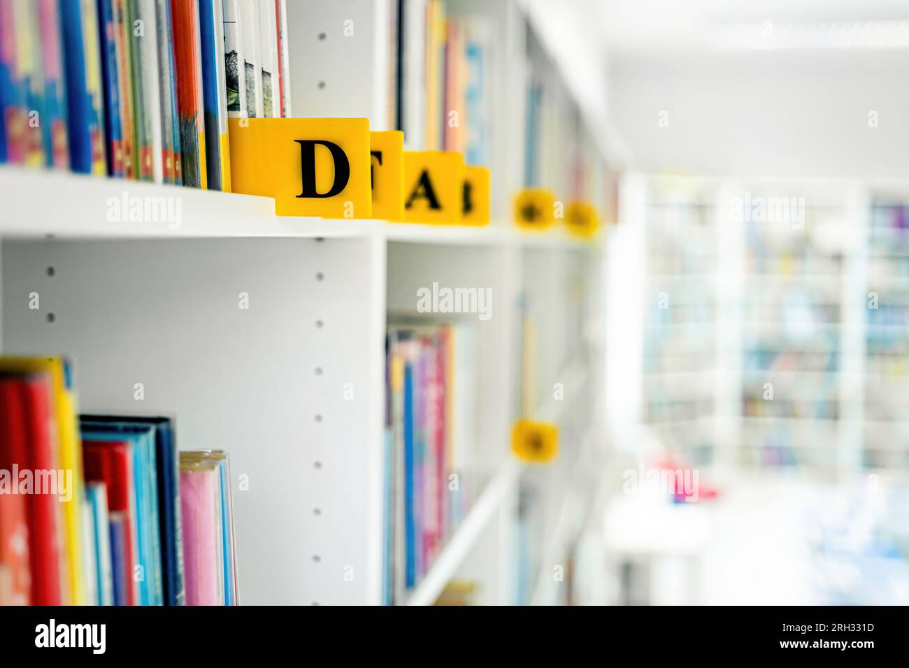 Books on shelves in the light library for kids. Authors of books placed ...