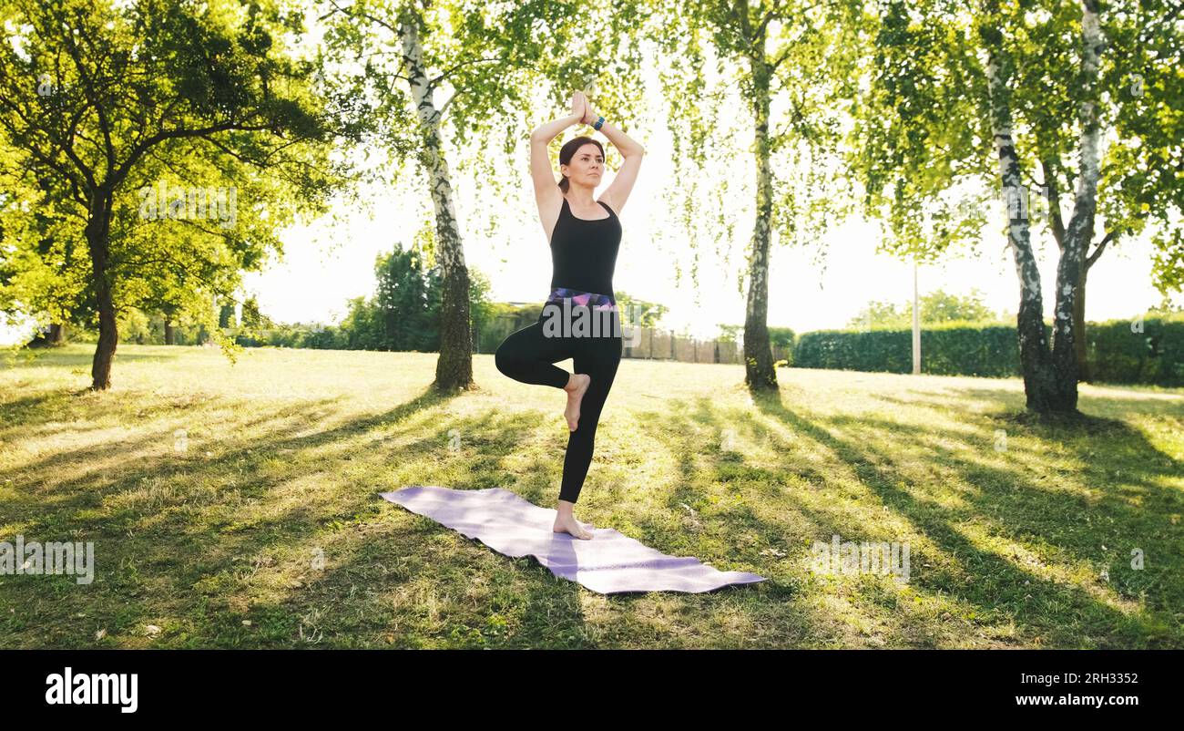 Fitness athletic Girl practicing yoga Outdoors standing standing on a ...