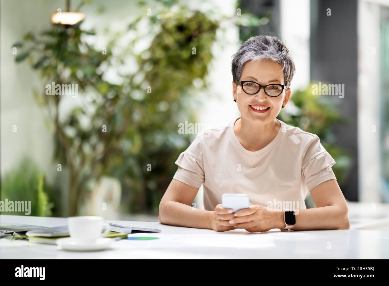 Happy middle aged woman manager enjoying coffee break at office Stock ...