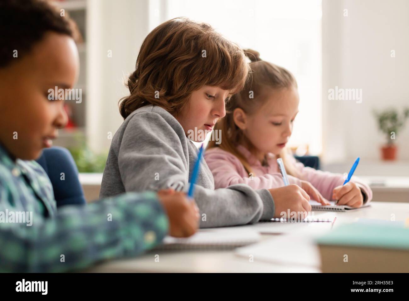 Multiethnic students writing test hi-res stock photography and images ...