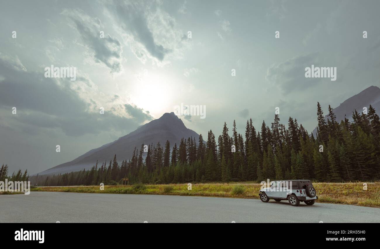 A 4x4 car is parked in a rest area on the highway in Canada with views ...