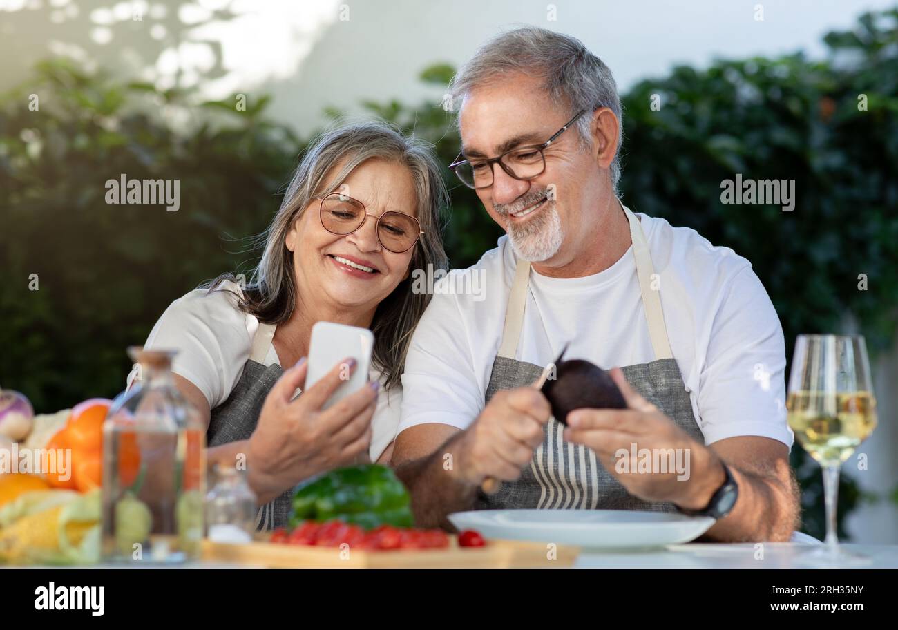 Cheerful married couple in aprons hi-res stock photography and images ...