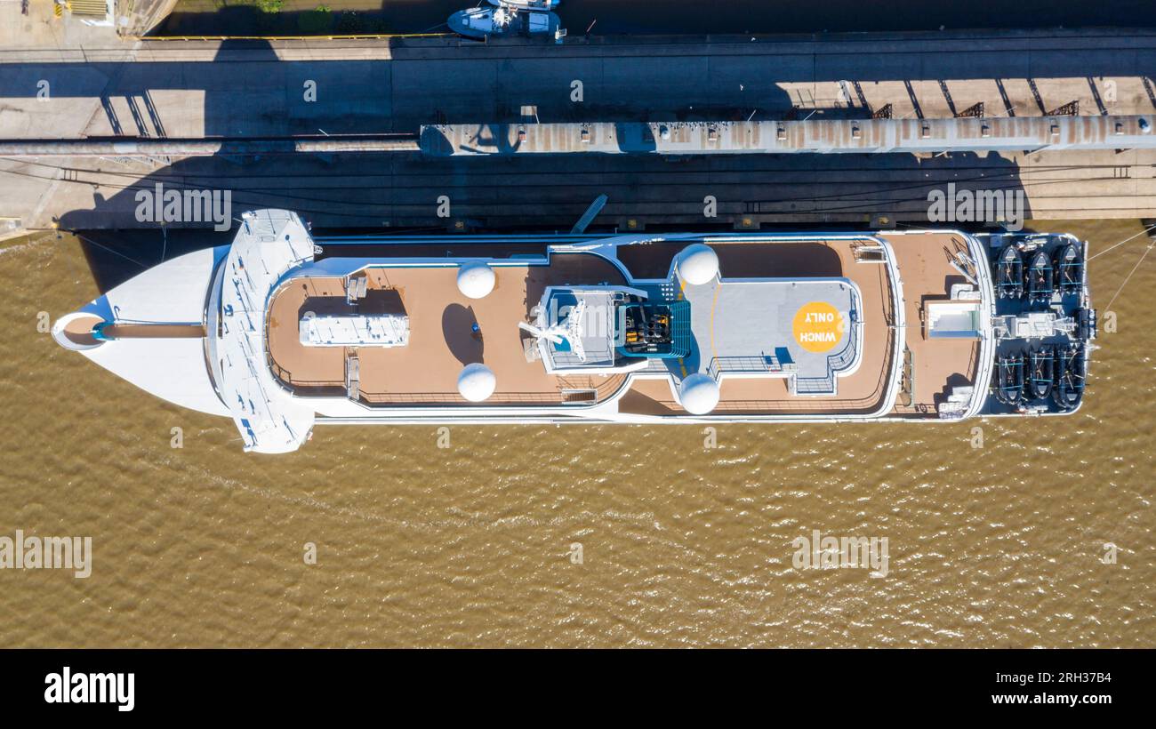 Expedition ship moored alongside in port. Multiple zodiac type boat on ...