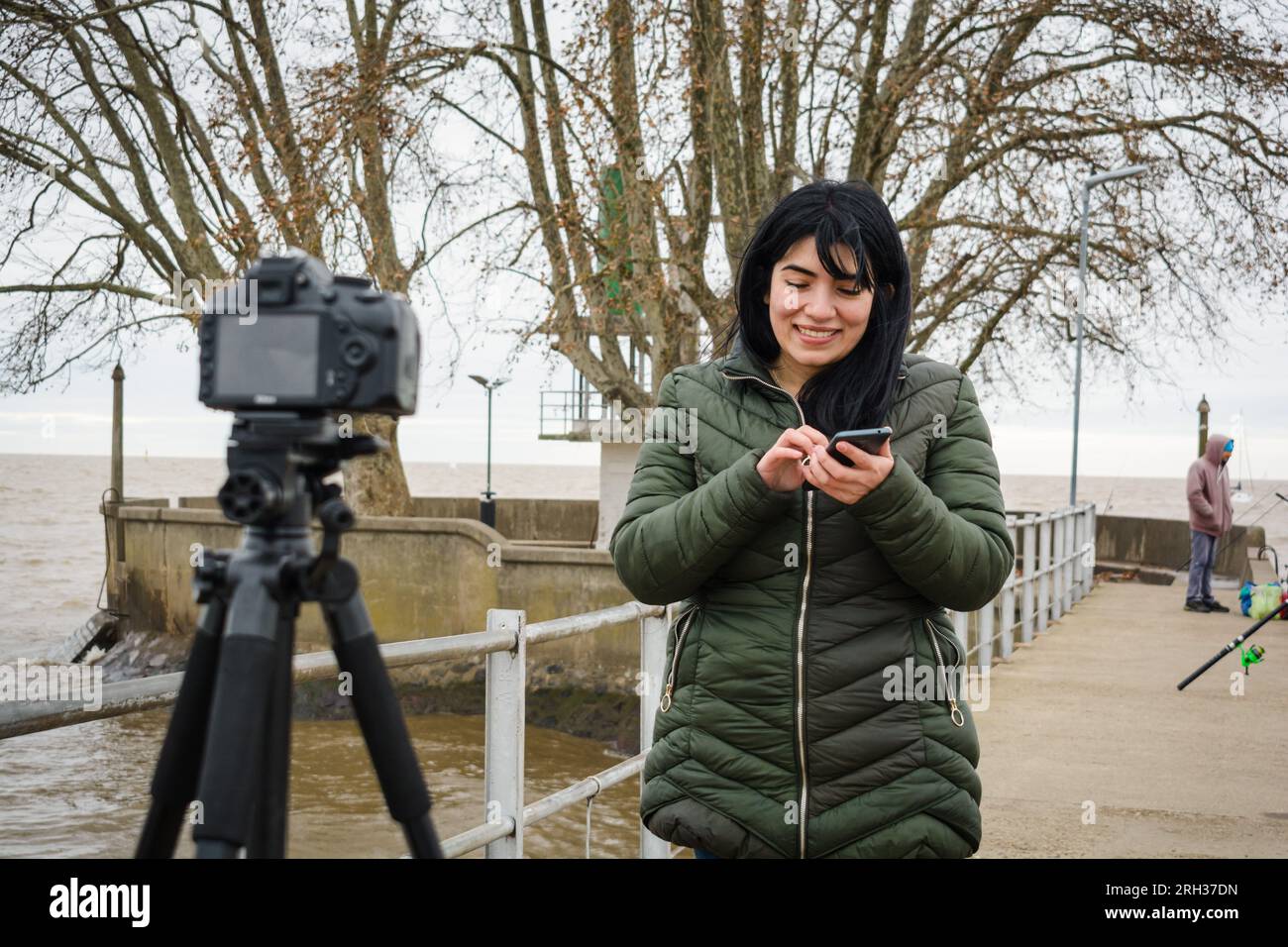 young latin venezuelan woman content creator standing with her camera ...