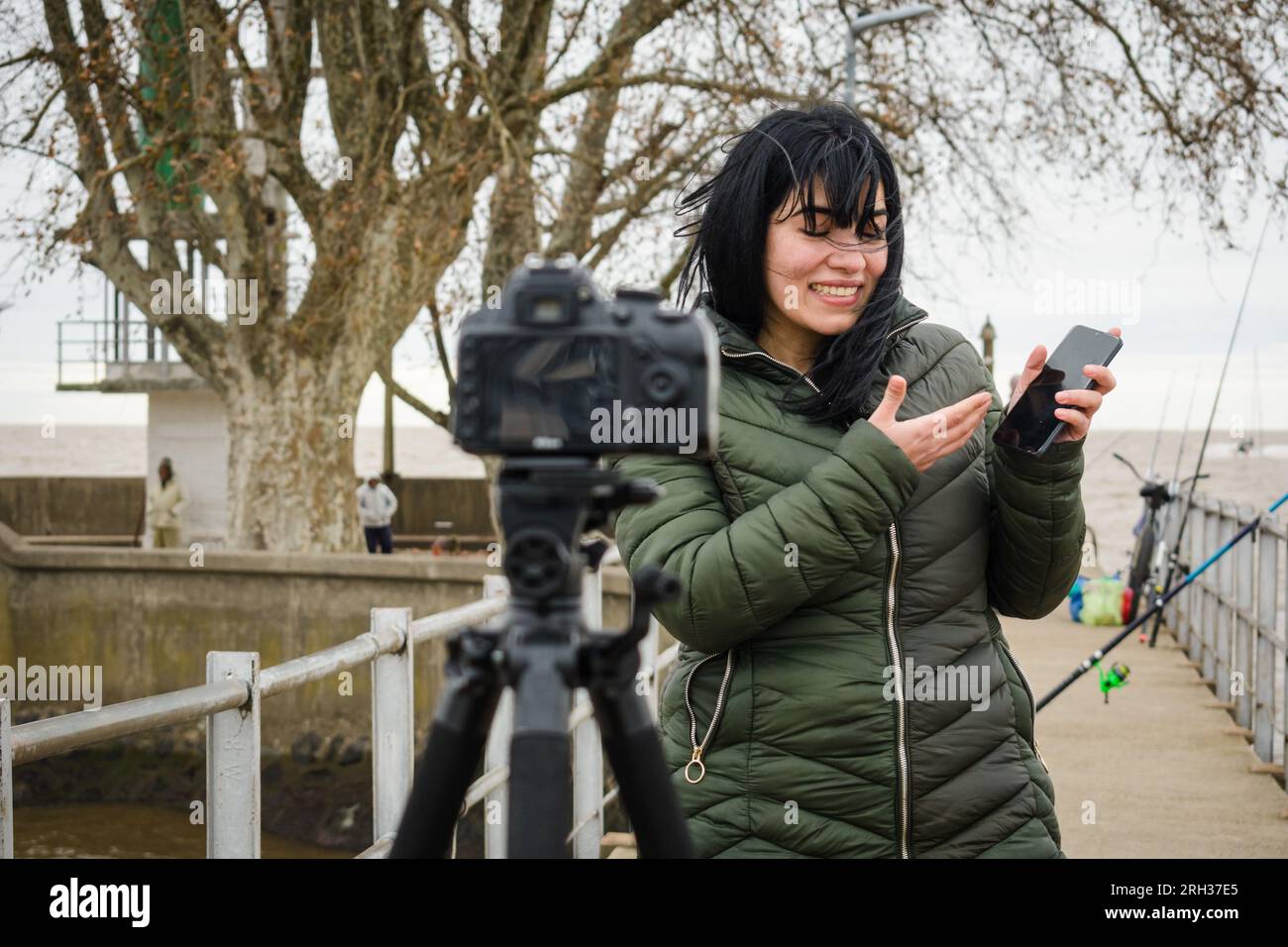 young latin venezuelan woman content creator standing with her camera ...