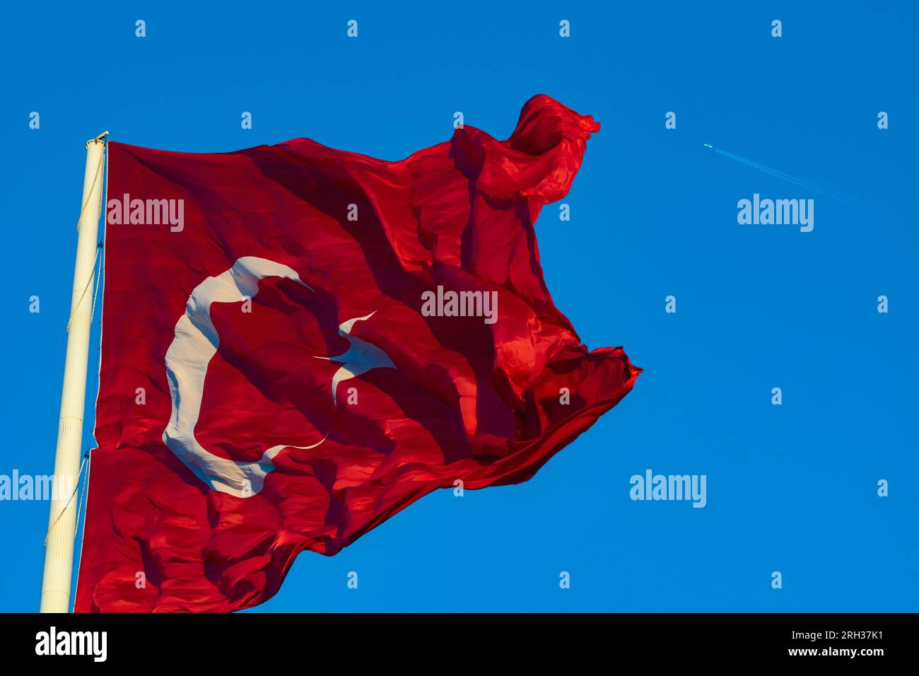 Waving Turkish Flag isolated on blue sky. Turkish national holidays ...