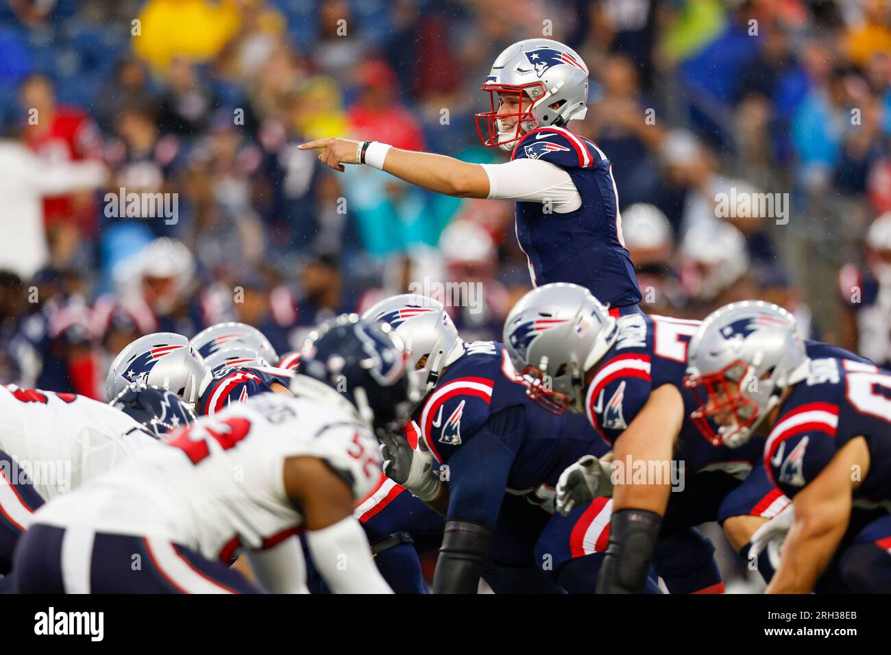New England Patriots quarterback Bailey Zappe (4) makes an adjustment ...