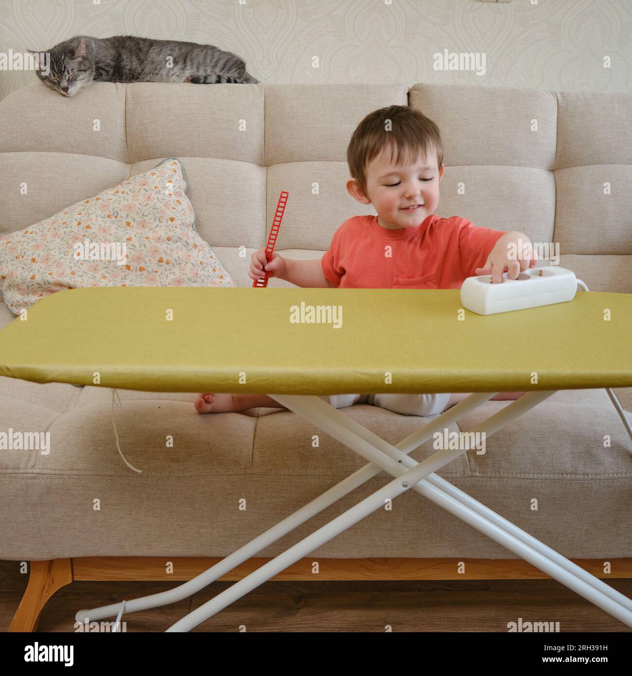 The baby's playtime with an electrical cord at home is a hazardous ...