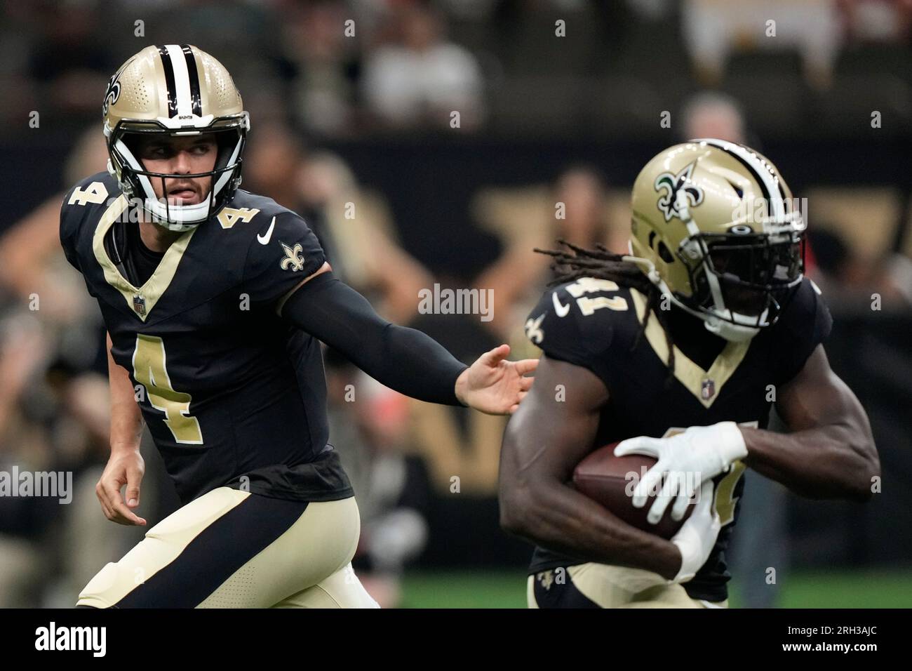 New Orleans Saints quarterback Derek Carr (4) hands the ball off to New ...