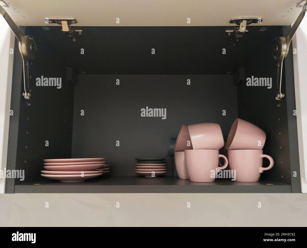 Top kitchen cupboard showing dishware. Handleless cupboards concept ...