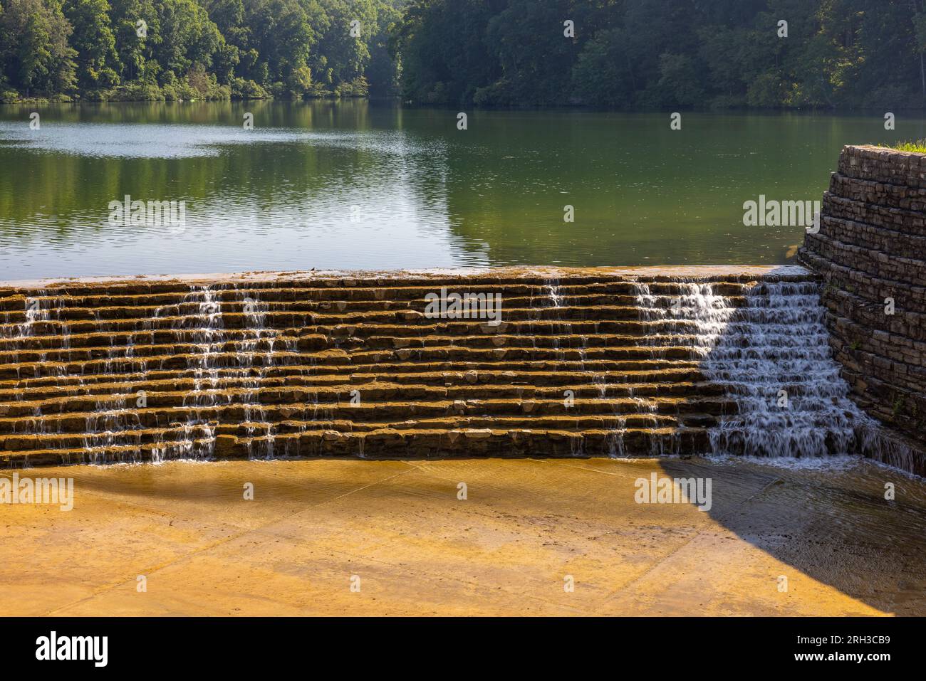 Stone Block Dam On A Lake Stock Photo - Alamy