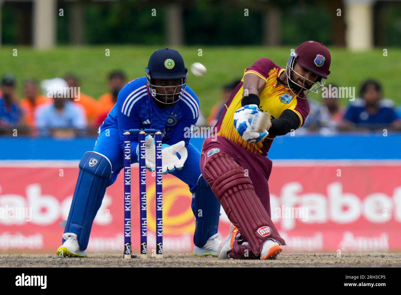 India's wicket keeper Sanju Samson watches West Indies' Nicholas Pooran ...