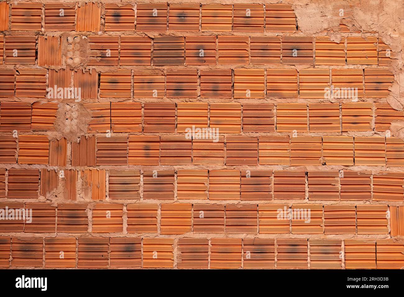 wall of ceramic brick blocks without plastering Stock Photo - Alamy