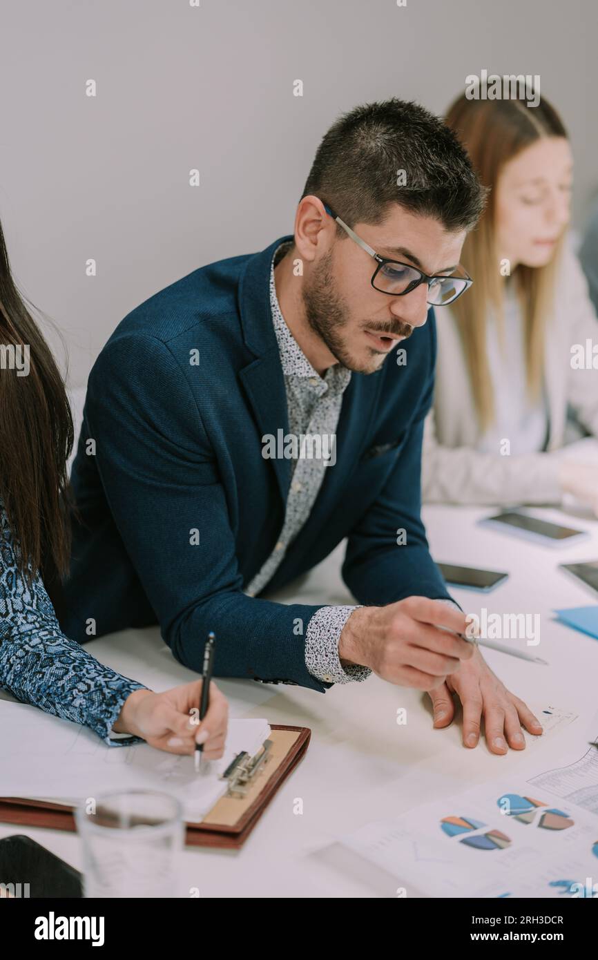 A close up photo of handsome male person calculating percentages from ...