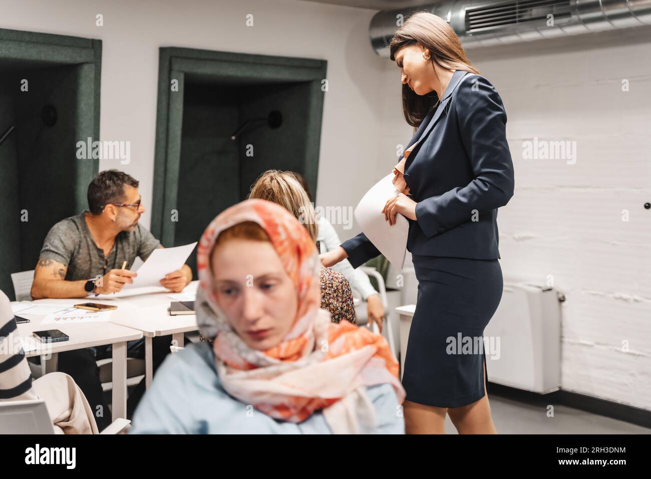 Inter-generational, multicultural group of people working together in a ...