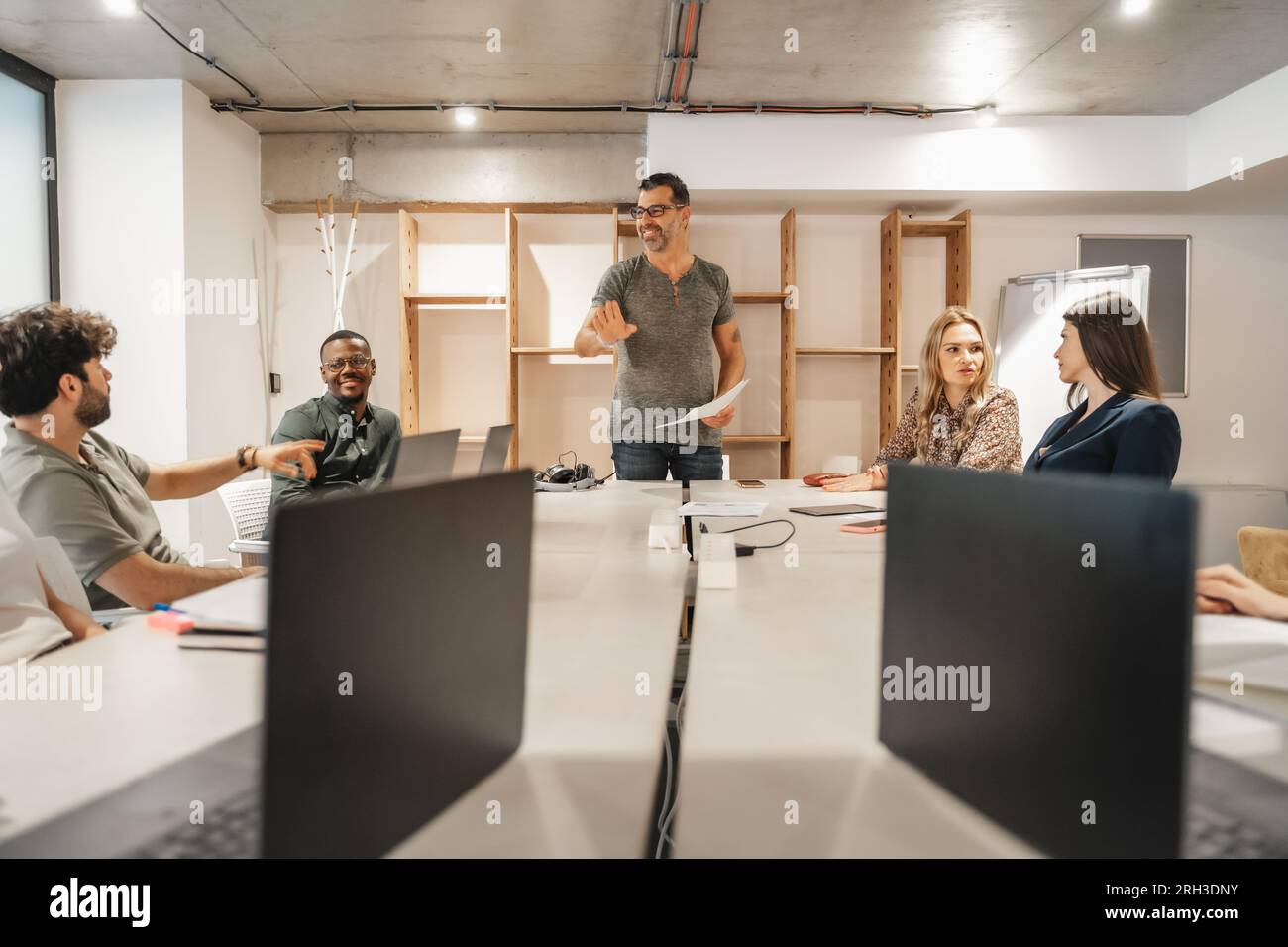 Handsome company boss working with his multiracial colleagues Stock ...
