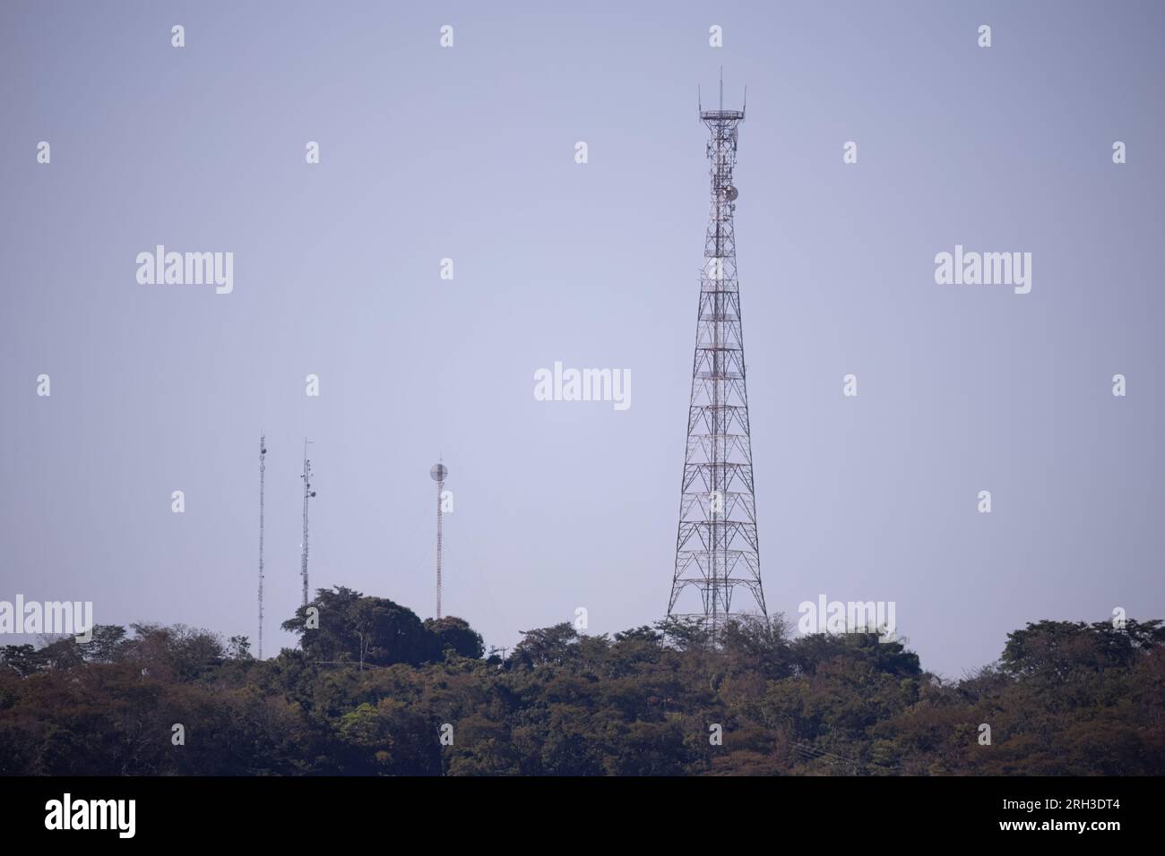 Metal telecommunication tower on top of a mountain range in the middle ...