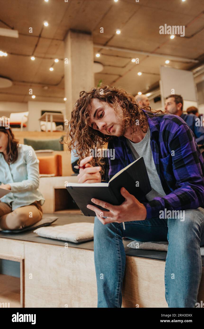Long curly haired male person reading notebook Stock Photo - Alamy Long curly haired male person reading notebook Stock Photo - Alamy