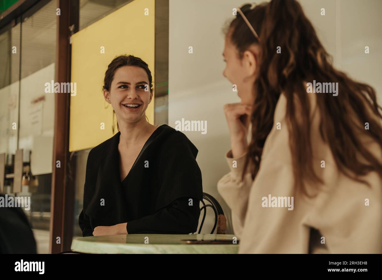 Lovely Smiley Brunette Girl Telling An Exciting Story About The Last