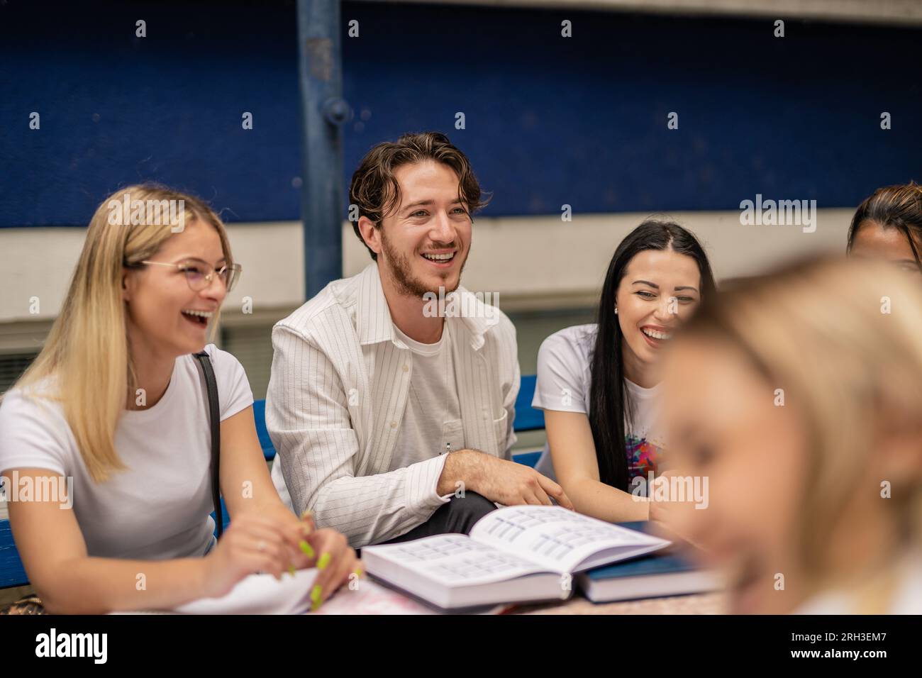 Intelligent students studying in a good atmosphere, having fun and ...