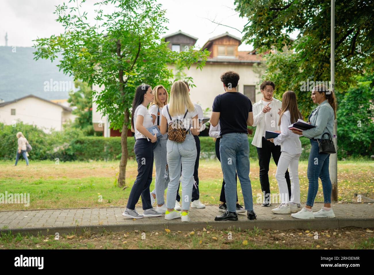Group of teenage high school students standing outside , talking and ...