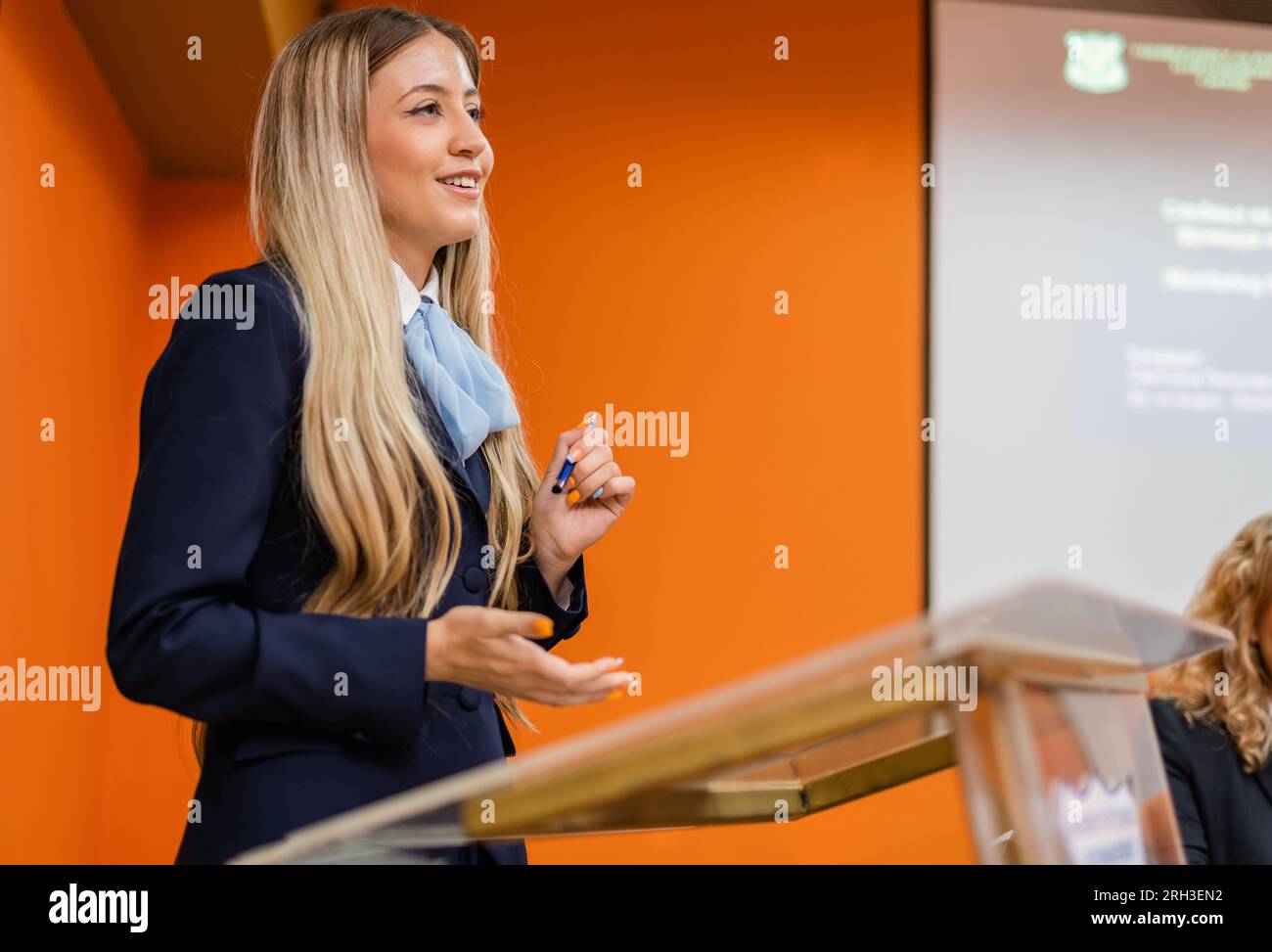 Female student giving a speech to her professors and classmates Stock ...