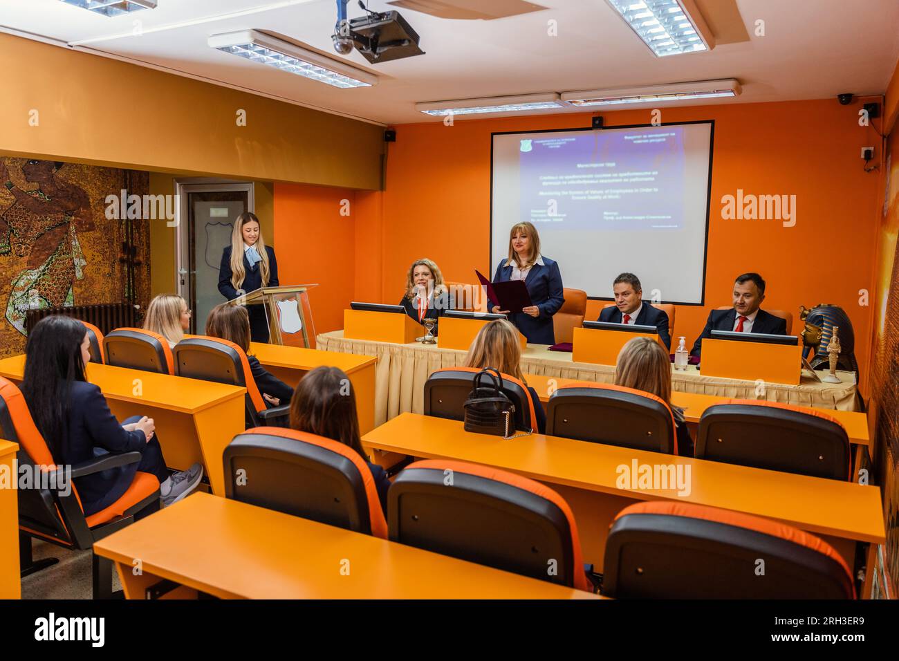 Group of students and professors getting ready to hear their student ...