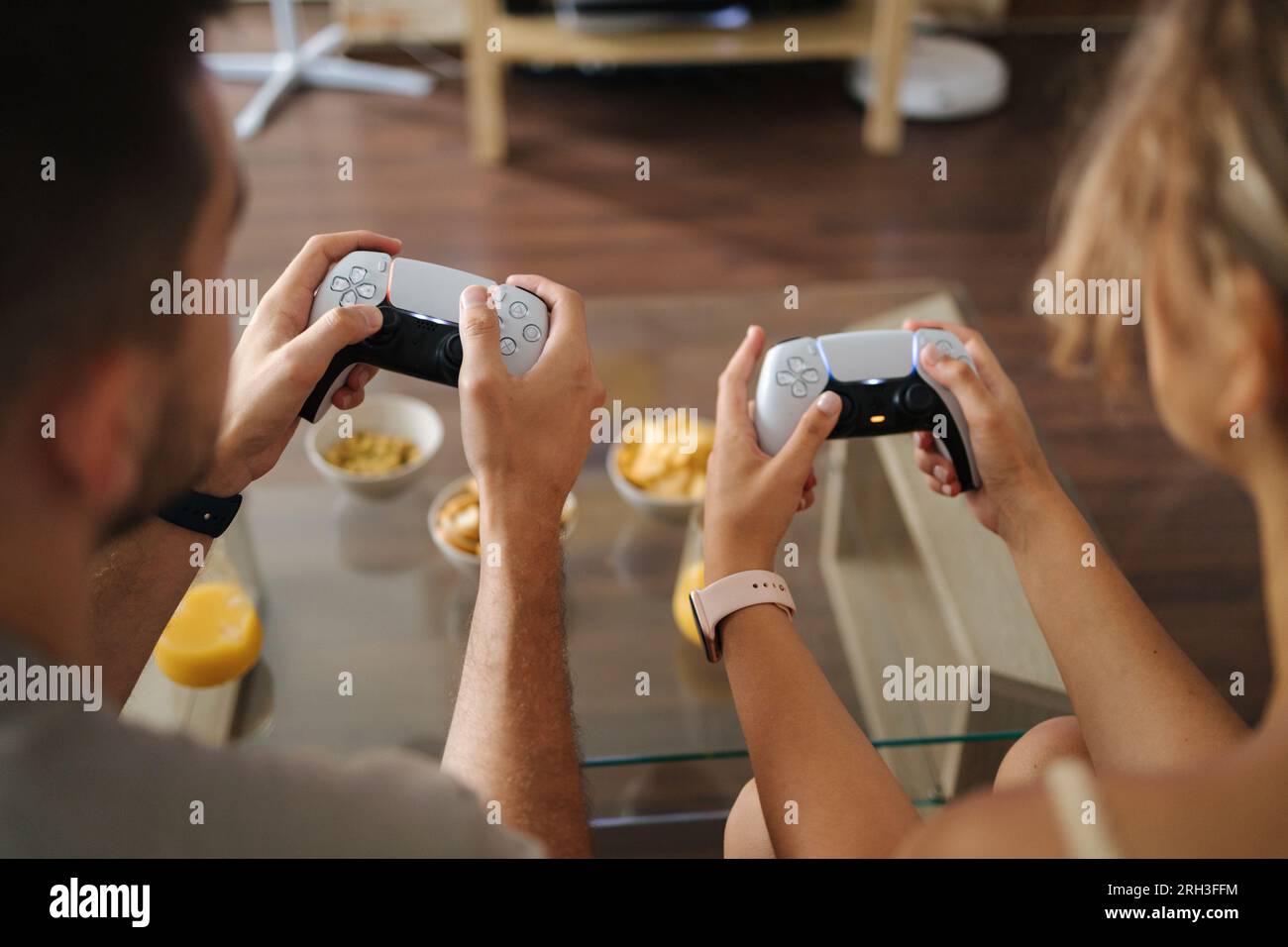 First person view of couple using joysticks to play video games on ...