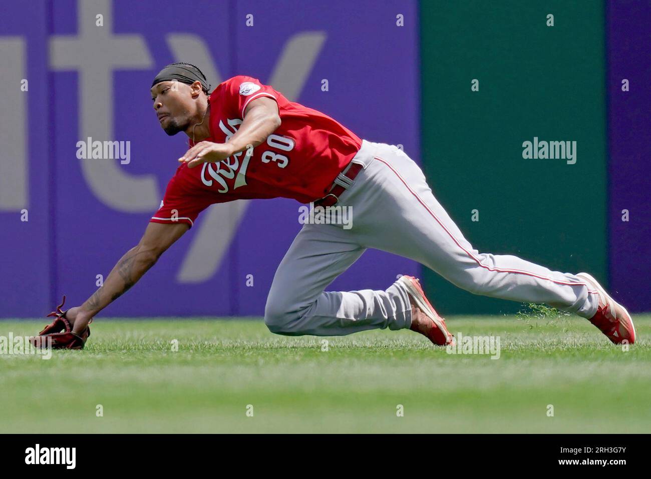 Cincinnati Reds right fielder Will Benson dives to pull in a line drive ...