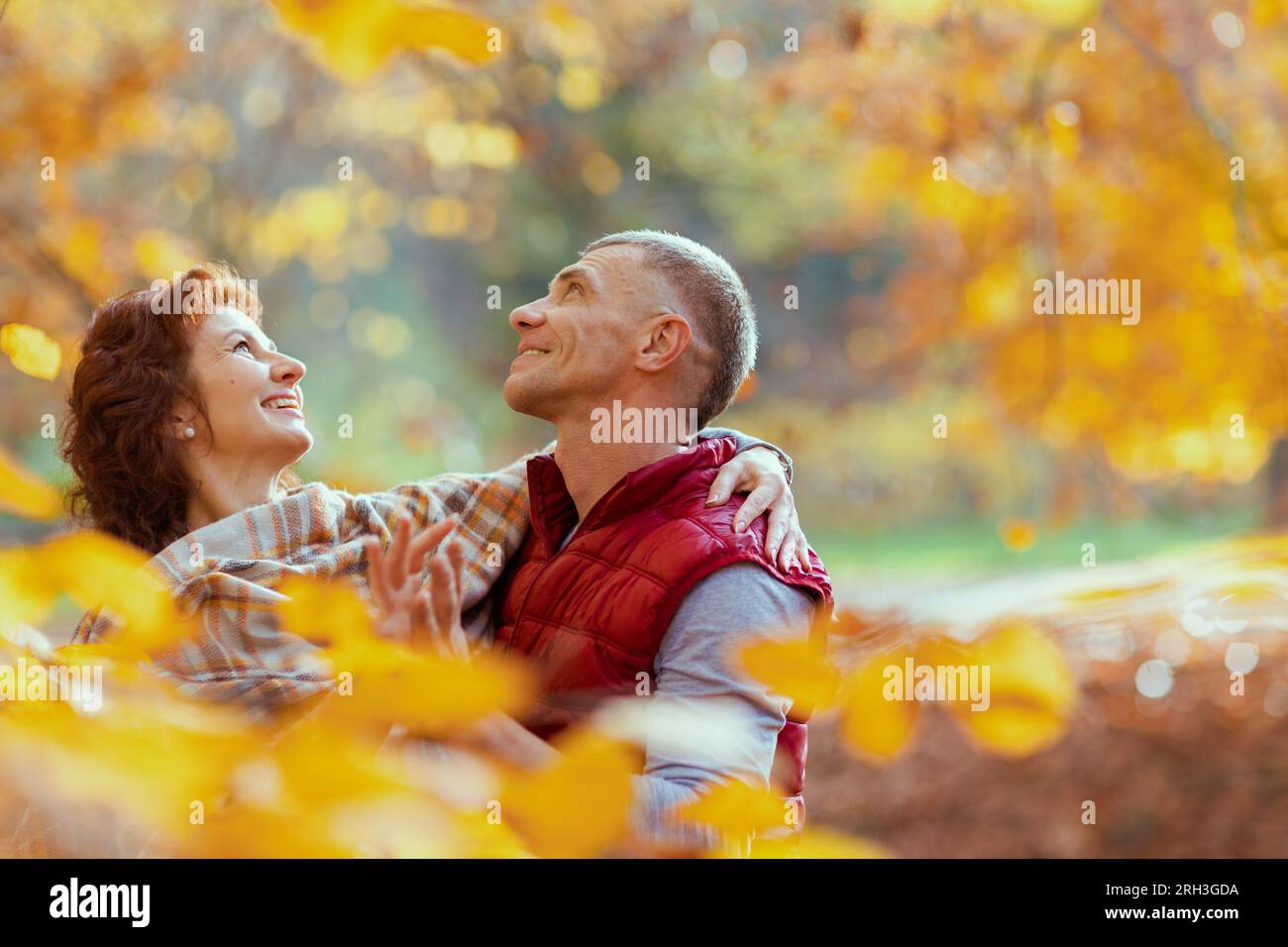 Hello autumn. happy modern couple in the park hugging Stock Photo - Alamy