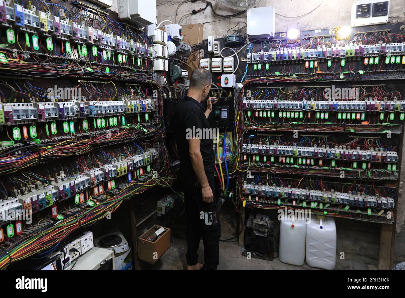 Baghdad, Iraq. 13th Aug, 2023. A man prepares an electricity generator ...