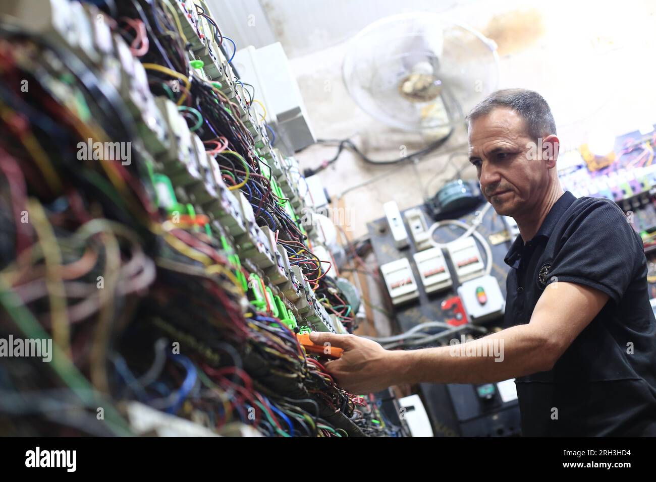 Baghdad, Iraq. 13th Aug, 2023. A man prepares an electricity generator ...