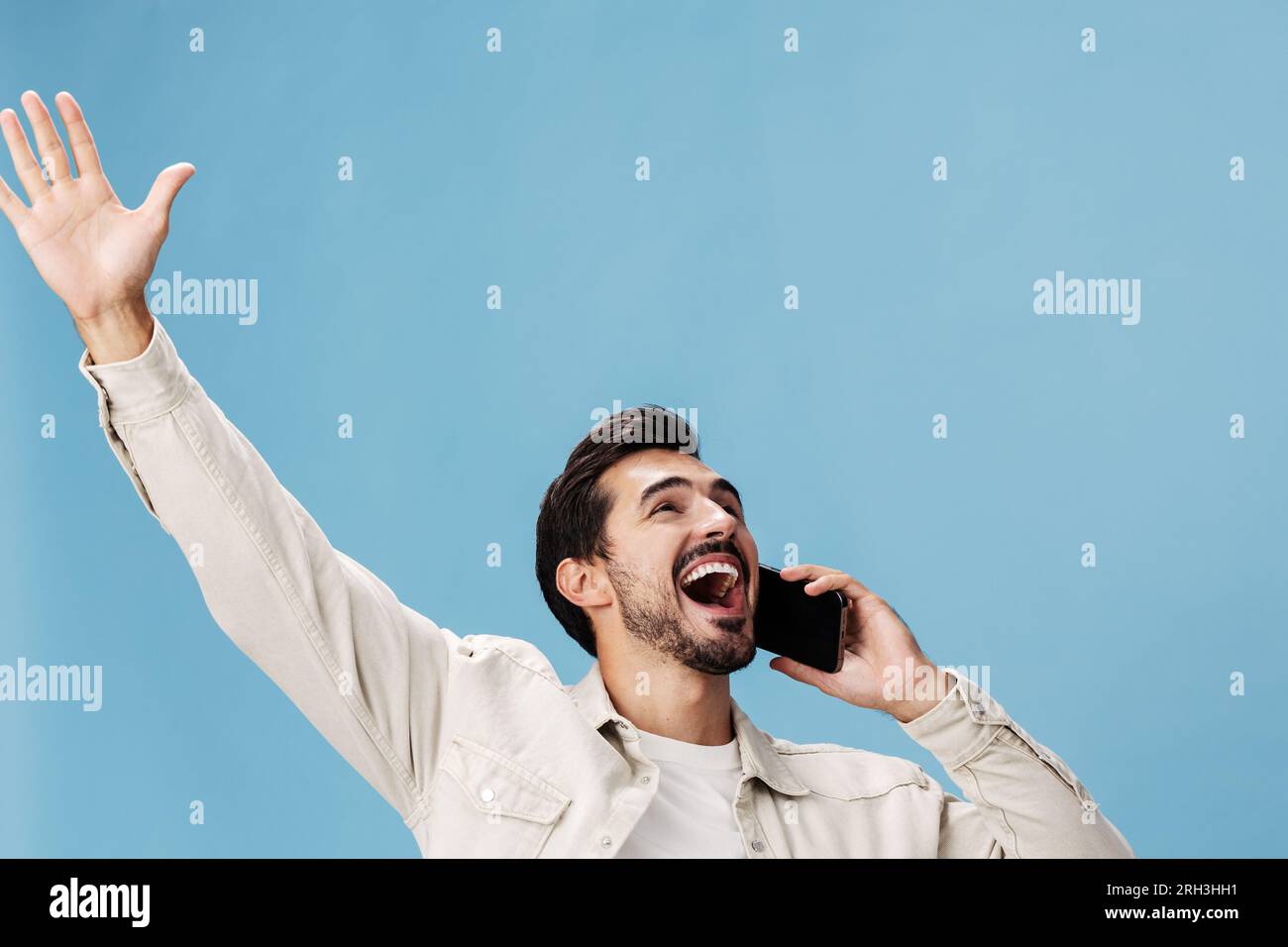 Portrait of a brunette man animation and joy talking on the phone hand ...