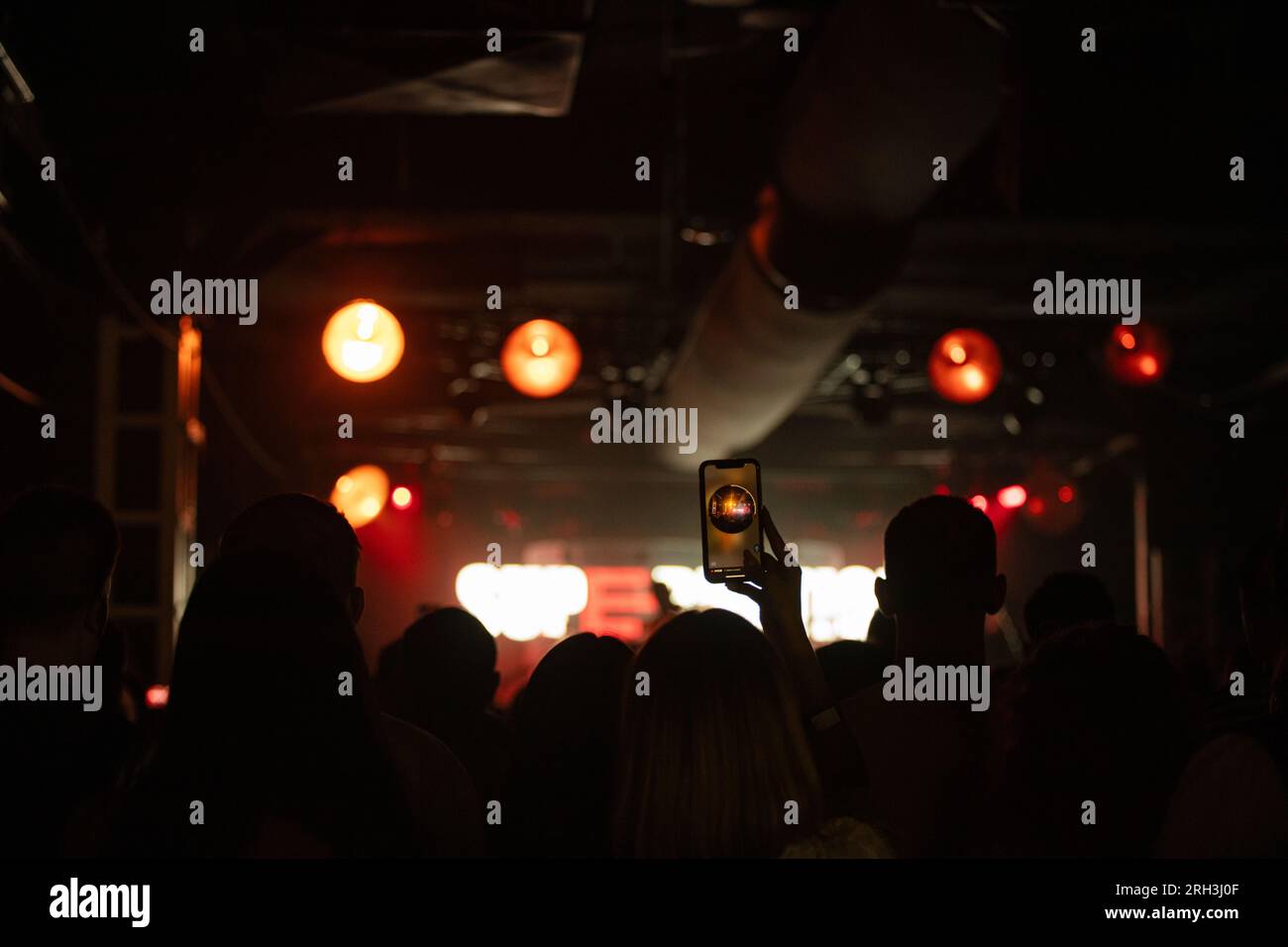 Hands holding phone and making photos on the concert. Concert ...