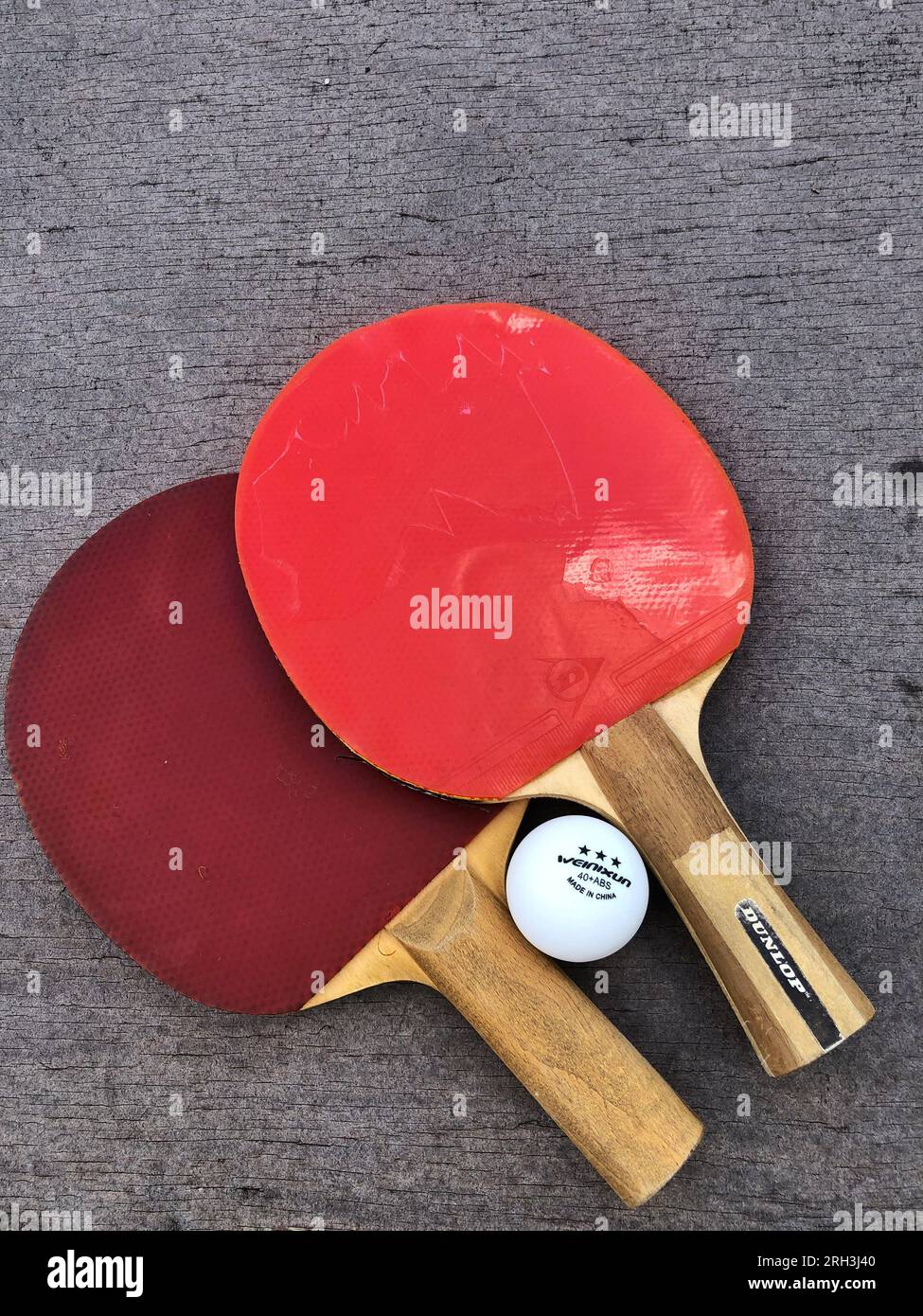 Two table tennis or ping pong rackets and balls on a blue table Stock ...