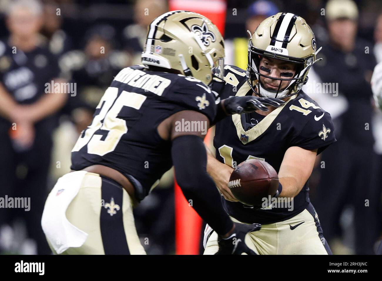 New Orleans Saints quarterback Jake Haener (14) hands off the ball to ...
