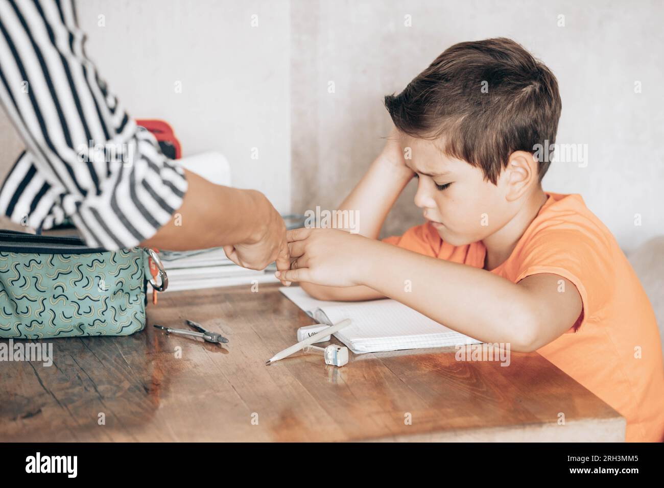 Mom ordering her schoolboy to do his homework Stock Photo - Alamy