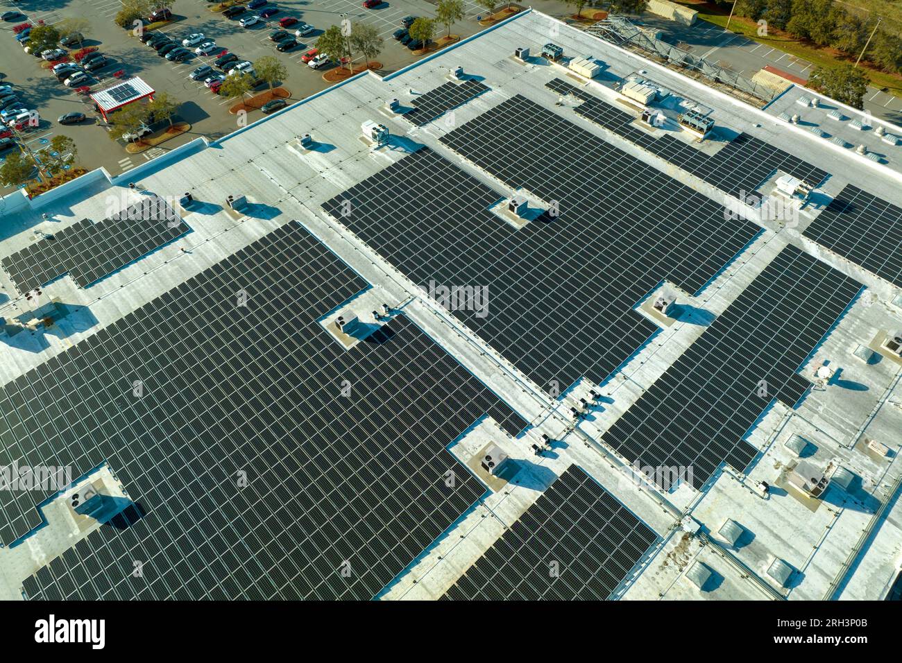 Aerial view of blue photovoltaic solar panels mounted on shopping mall ...
