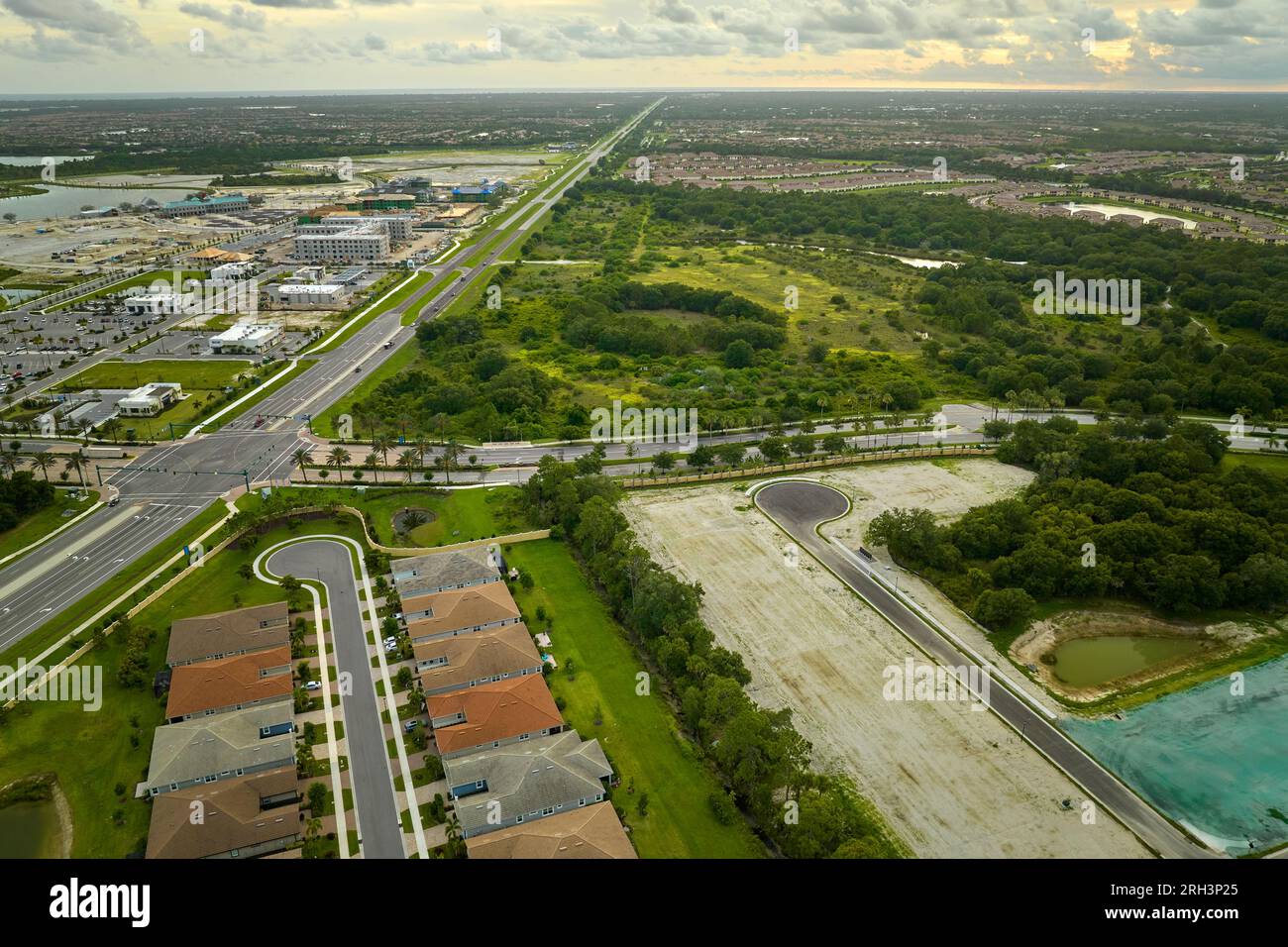 Aerial view of construction site with new tightly packed homes in ...