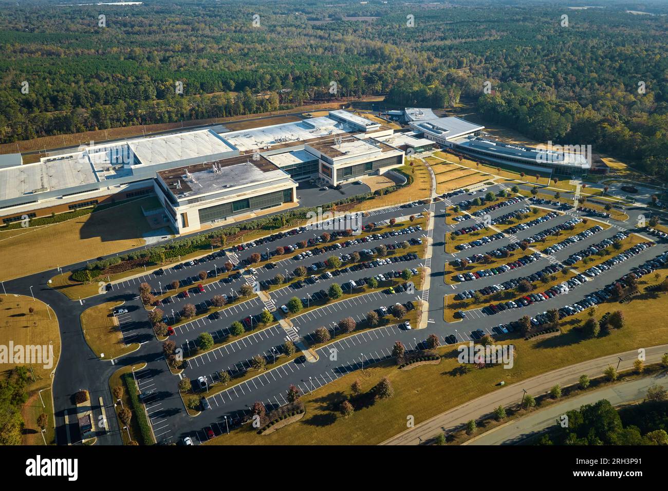 Aerial view of many employee cars parked on parking lot in front of ...
