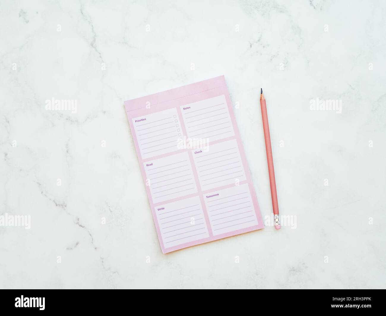 Pink blank planner sheet and pencil on white marble background. Mockup ...