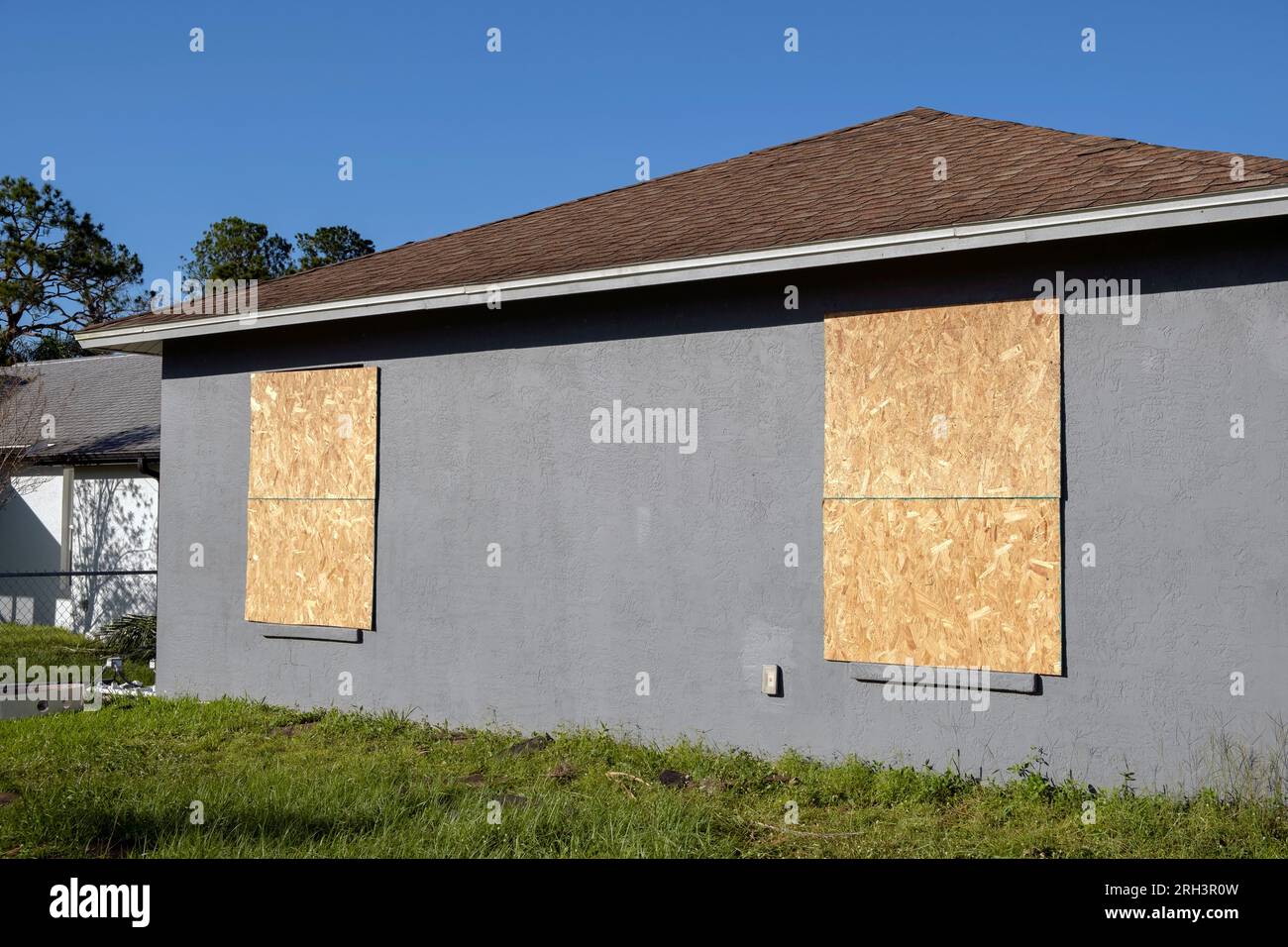 Boarded up windows with plywood storm shutters for hurricane protection ...