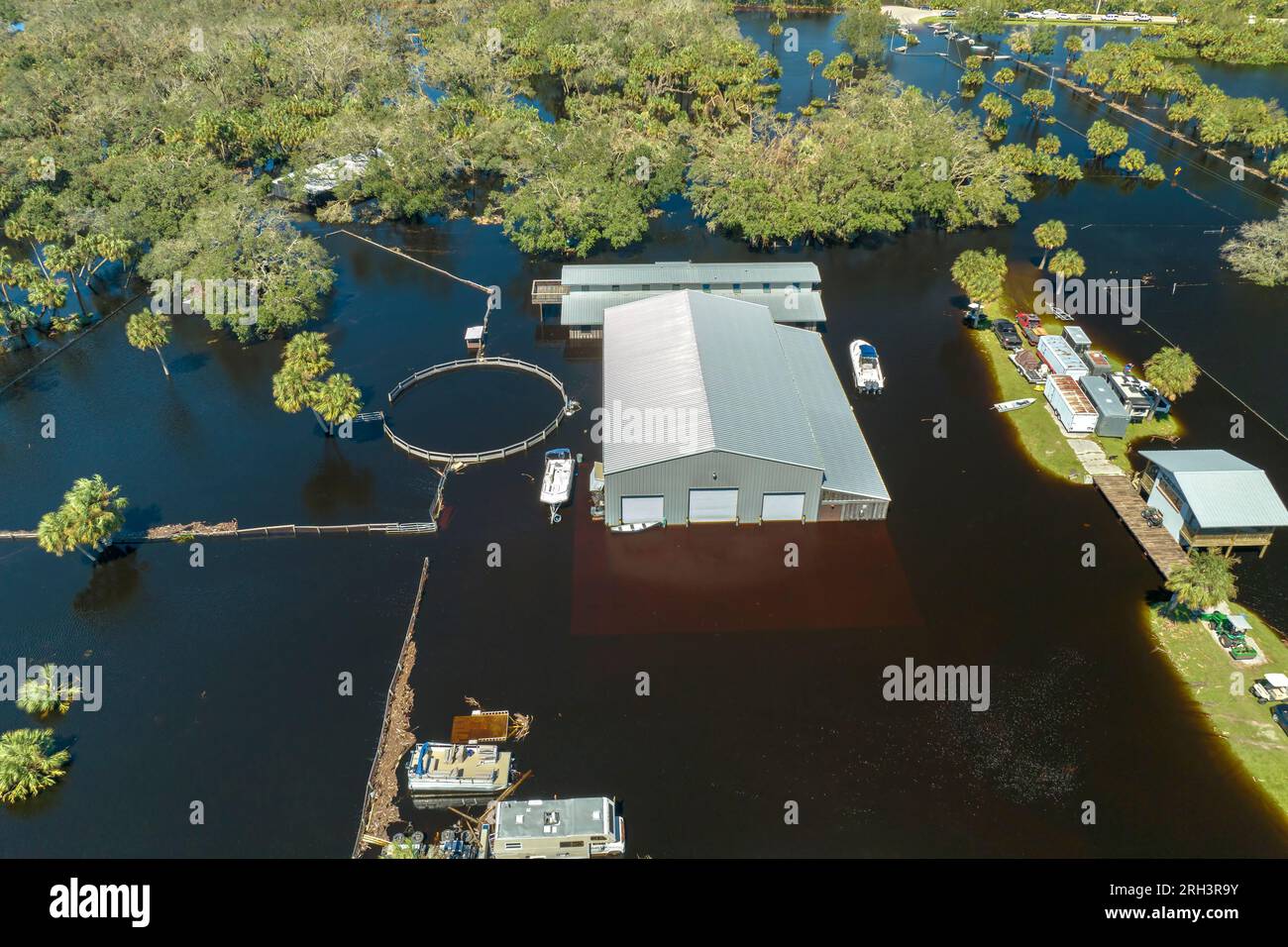 Consequences of natural disaster. Flooded industrial business warehouse ...