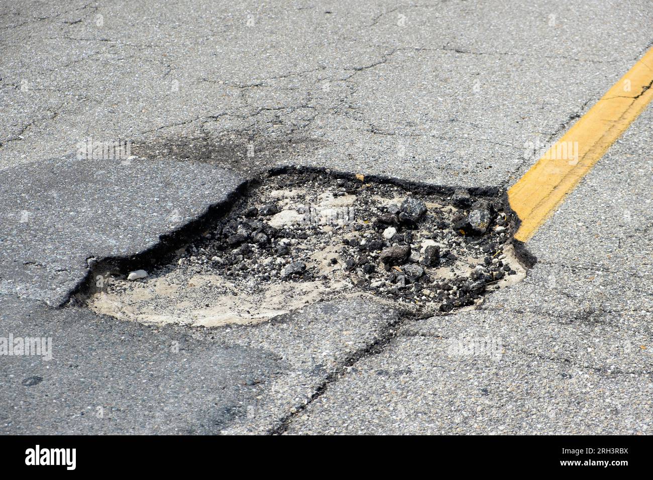 Damaged asphalt road with deep pothole on american highway surface ...